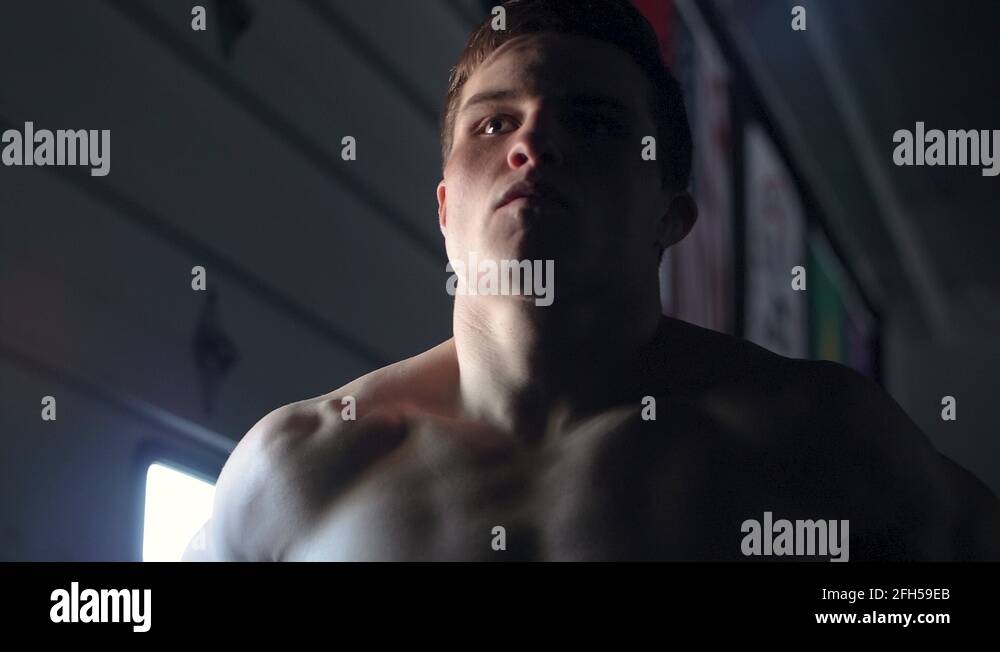 Sexy attractive shirtless male MMA fighter flexes his chest muscles in ...