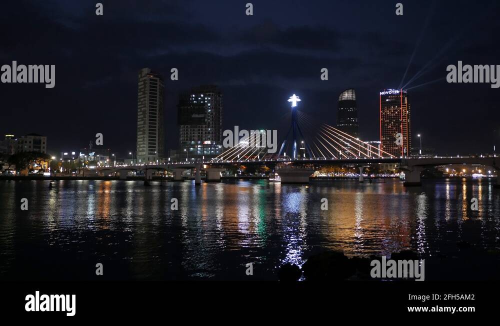 Tour boat passing under Song Han bridge with lights in evening,Danang ...