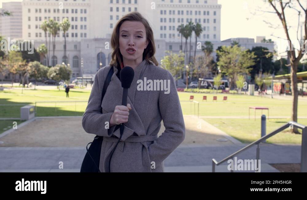 MS Female TV reporter in front of City Hall in Downtown LA 4K Stock ...