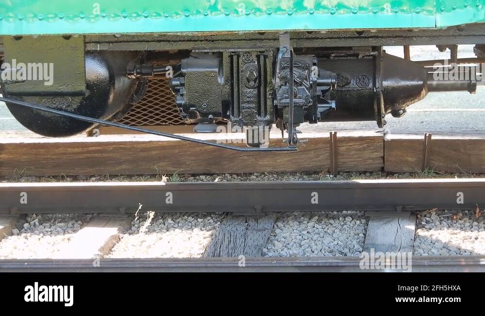 4K Train Tracks With Train Bottom Pan Left To Right Stock Video Footage ...