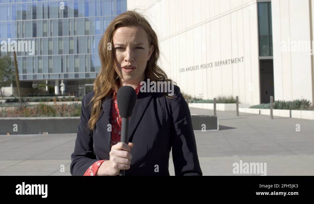 MS Female TV reporter in front of Los Angeles Police Dept headquarters ...