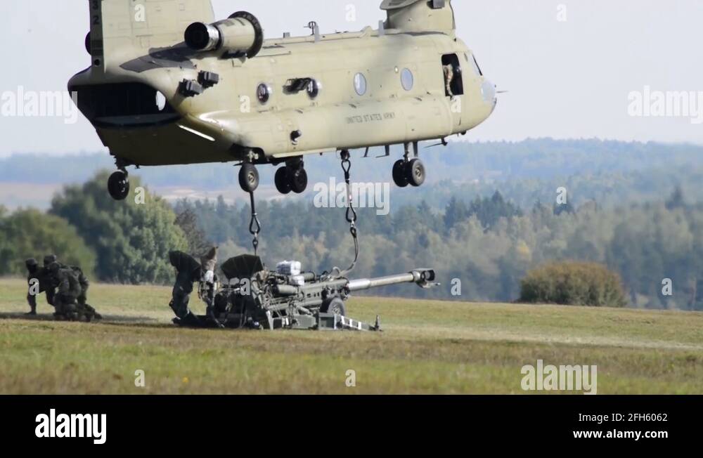 Boeing CH-47 Chinook lift M777A2 howitzers during sling load operation - 2016 Stock Video ...