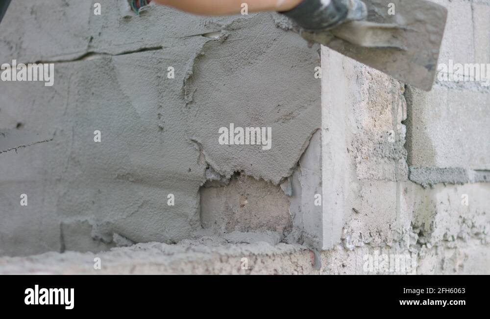 Worker labor building wall and UPVC groove line with plaster cement ...