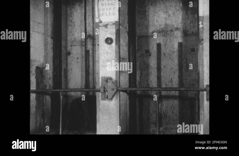 1950s: Elevator in mine carries rocks and minerals up from mine to tall ...