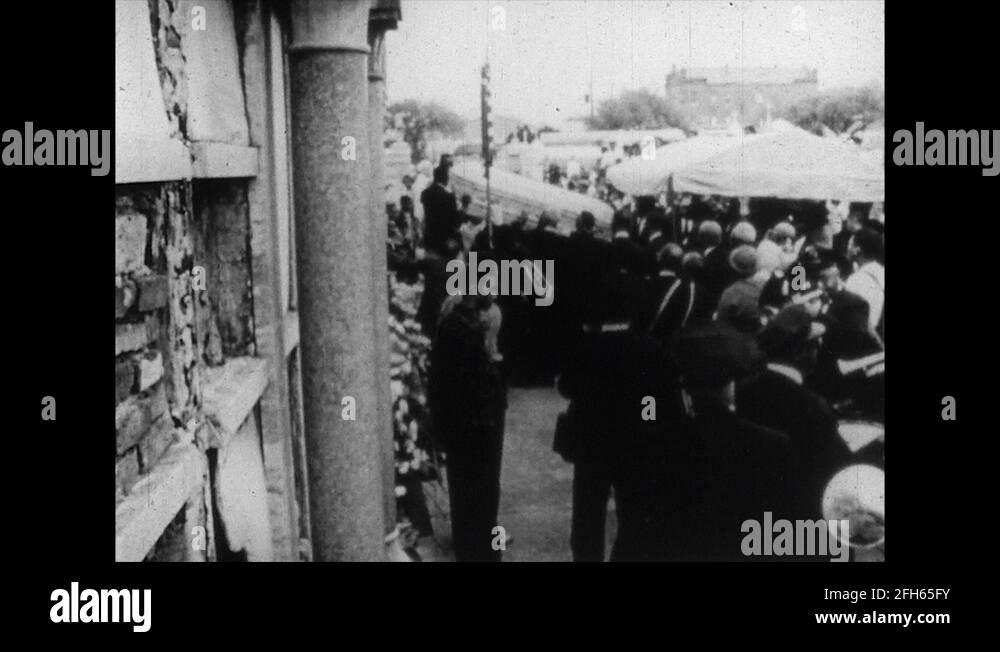 1960s: Funeral procession reaches cemetery, casket is raised and ...