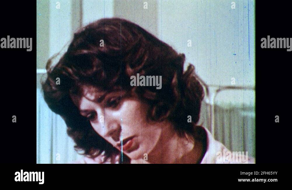 1960s: Women look panicked and concerned. Nurse speaks and shakes head ...