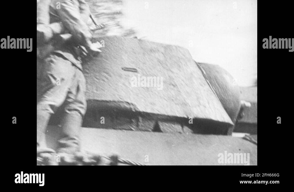 1940s: Soldiers ride on tanks. Tanks fire and soldiers disembark. Tanks ...