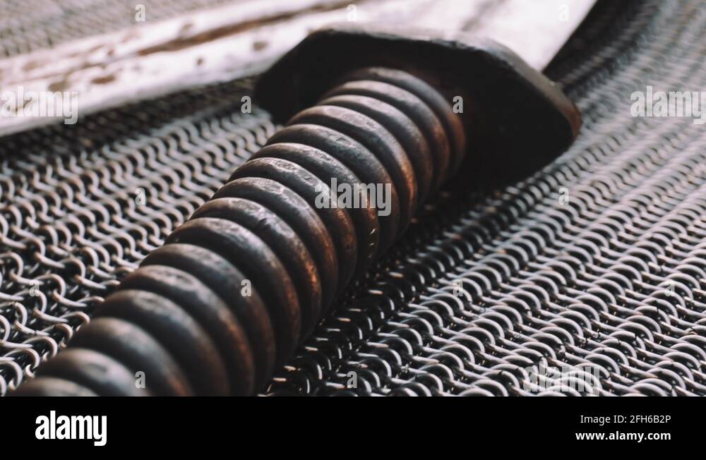 Crossed swords on chain armor, close up, historical ancient weapon ...