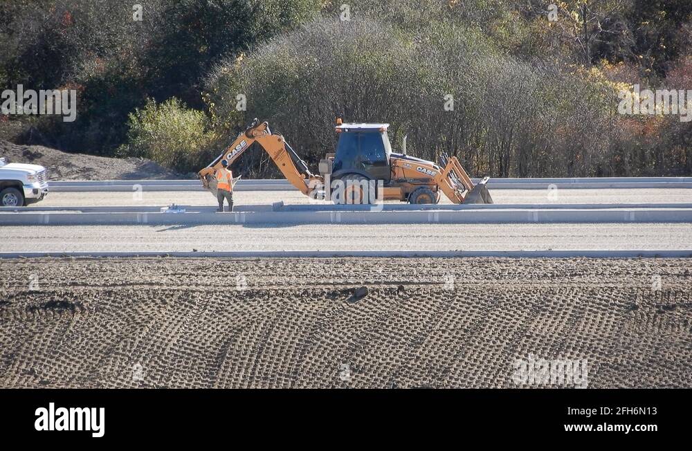 TLB Tractor Loader Backhoe On Construction Site With Worker 4K Stock ...