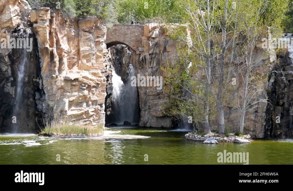 Starting wide then zooming in on beautiful man-made waterfalls at a ...