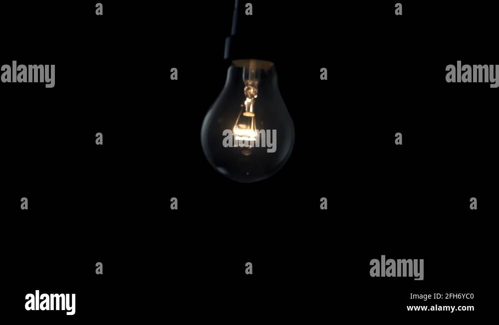 Light bulb swinging in slow motion. 4k Black background Stock Video ...
