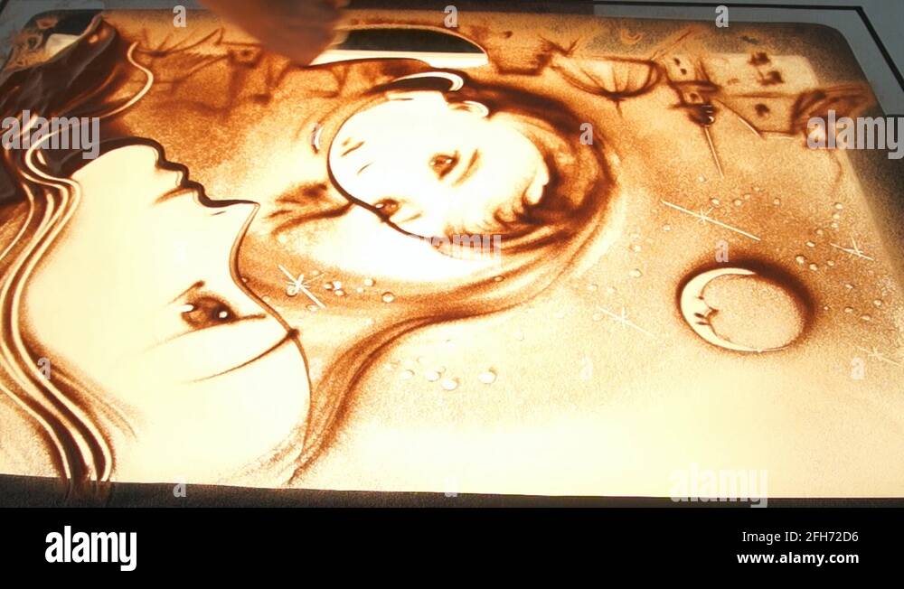 Drawing with sand. Drawing sand on a white screen. Sand Artist. Hands ...