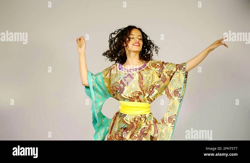 pretty african woman is leaping and whirling, dancing traditional folk ...