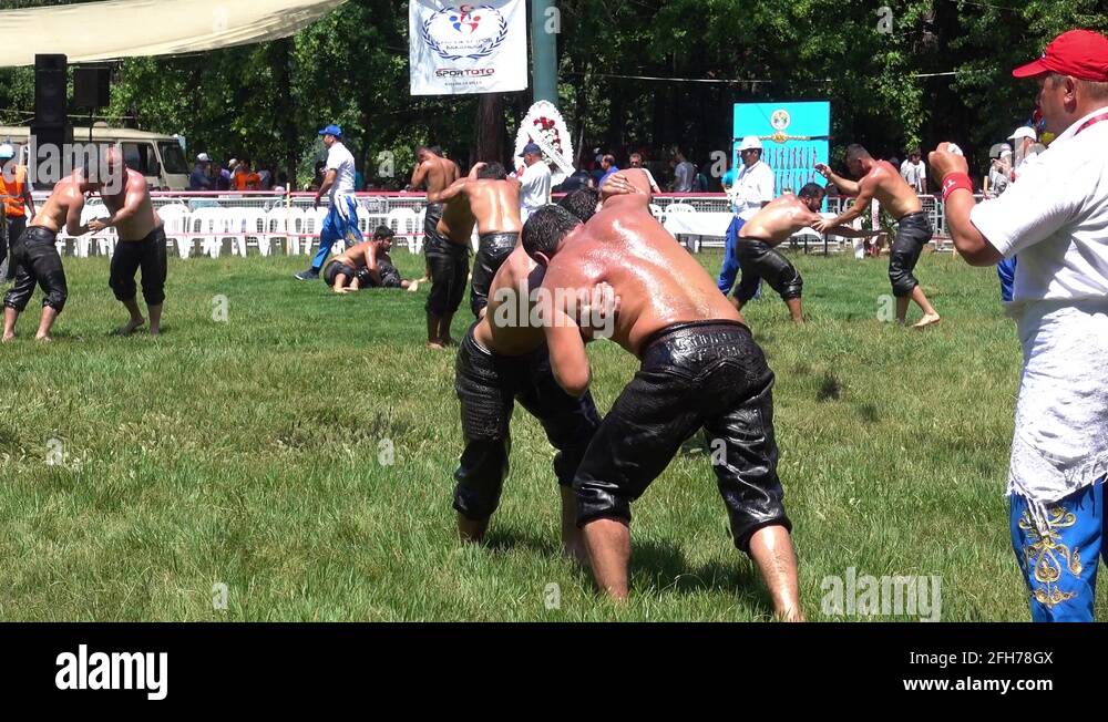 Zoom out oil wrestling pairs and referee Stock Video Footage - Alamy
