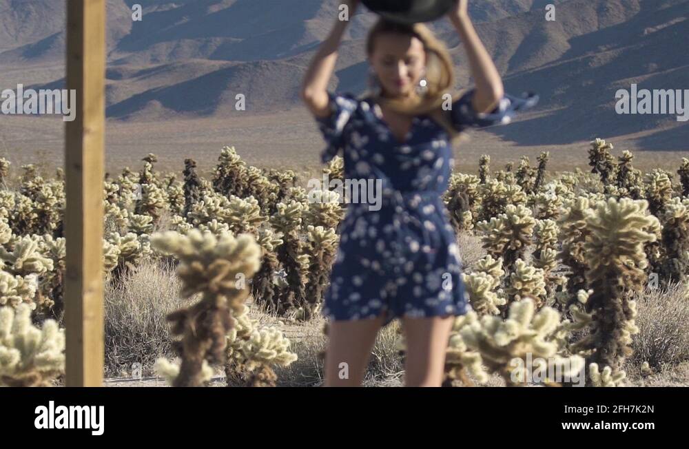 woman dresses and loses her hat Stock Video Footage - Alamy