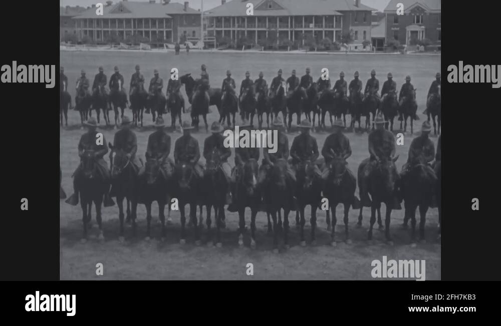 WW1 - Cavallery soldiers on horses stand in line in front of building ...
