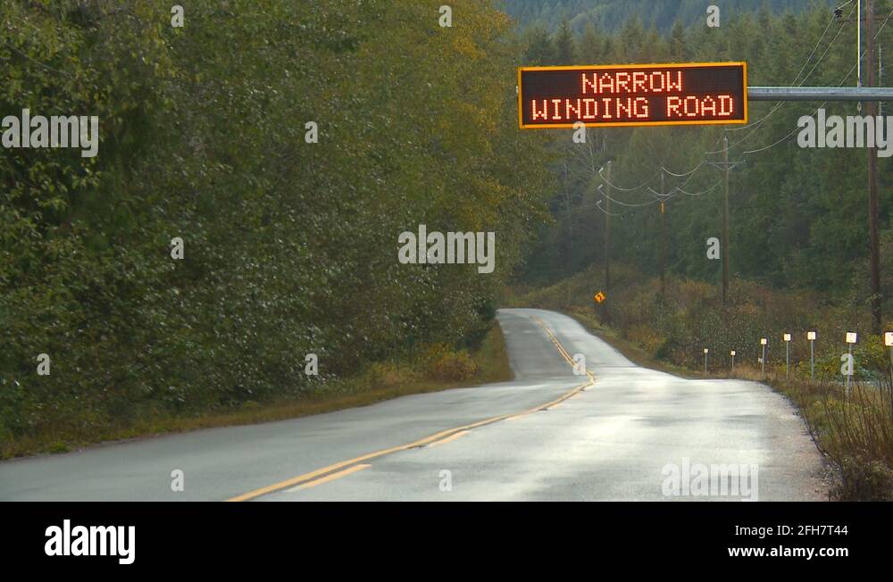 sign, narrow winding road sign, no traffic, two shot Stock Video ...