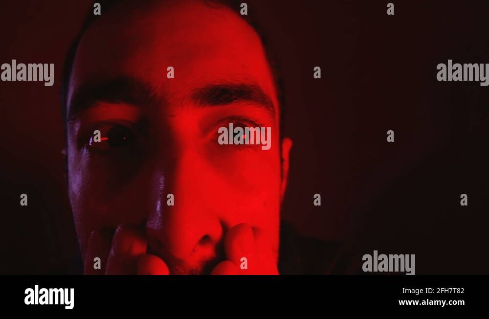 Man with shocked facial expression moves his eyes from side to side ...