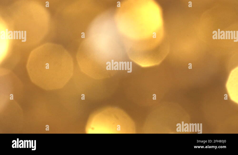 Abstract Gold bokeh lights in motion in 4k video. High quality render ...