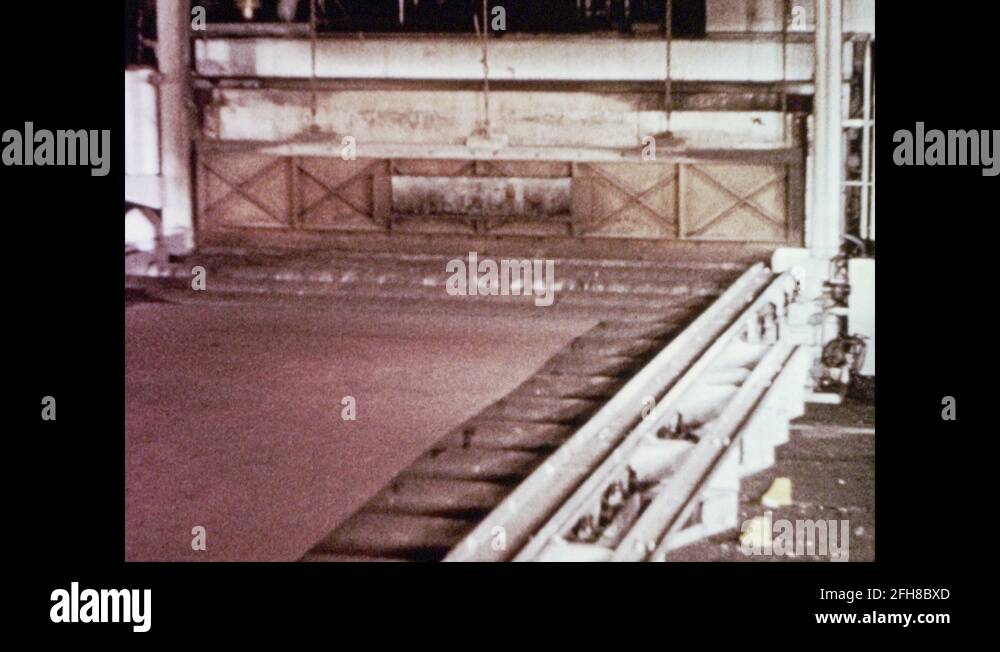 1950s: Steel furnace door opens. Steel plate is pulled into furnace ...
