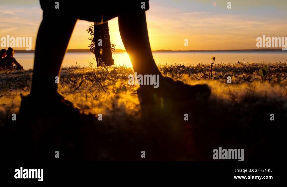The legs of a boy running in the setting sun. Silhouette, picking up dust and Stock Video ...