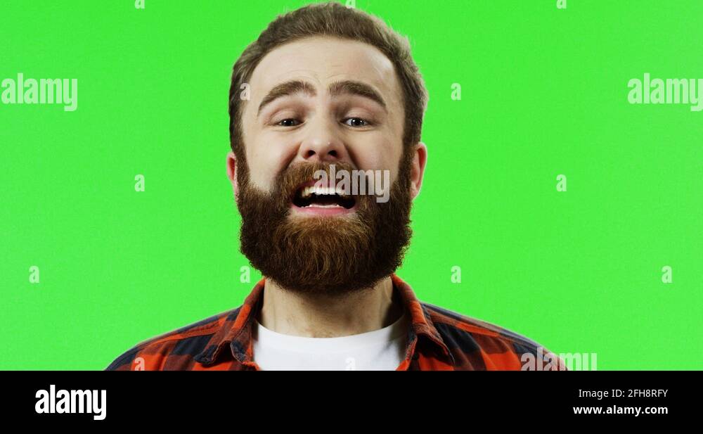 Close up of the emotional man with a beard screaming and making a wry ...