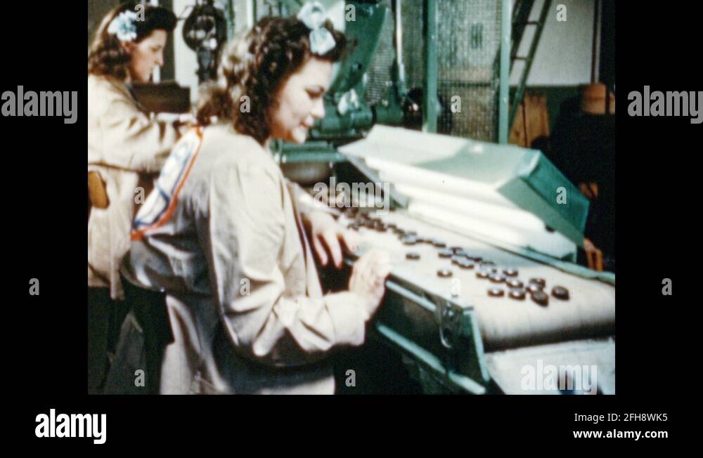 1950s: UNITED STATES: lady inspects bottle caps on conveyor belt. Close ...
