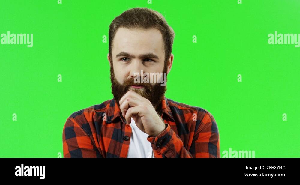 Portraitor of the young caucasian man inventor thinking on the green ...