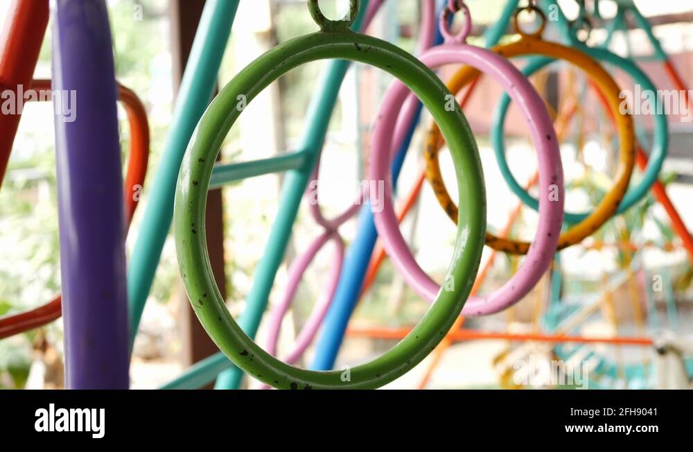 colorful steel loop hanging climb in playground for kids playing ...