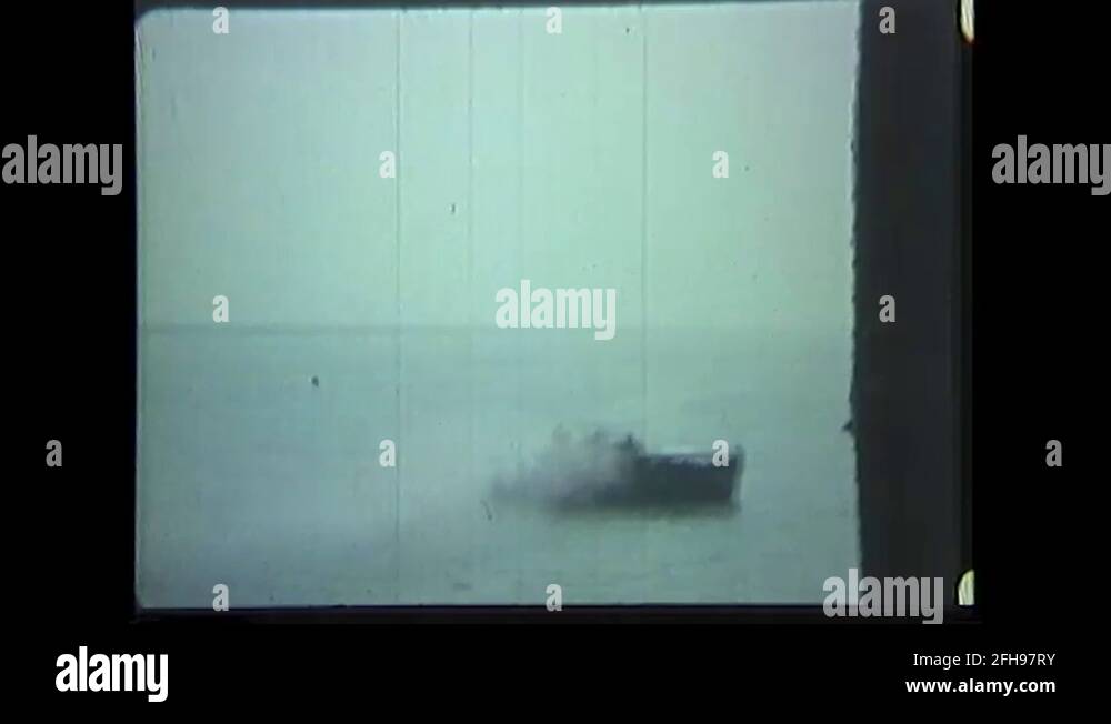 Copter lands on a US Navy boat pad, a wounded soldier is helped to ...