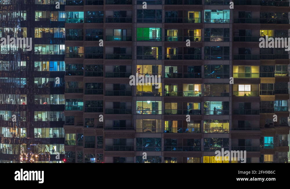 Windows of the multi-storey building of glass and steel lighting inside ...