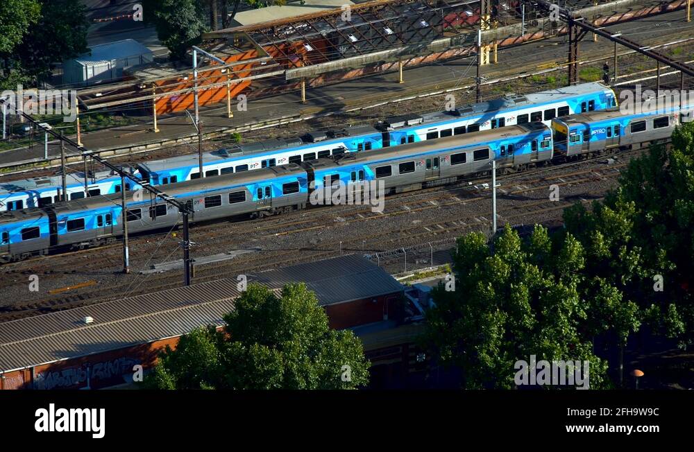 Comeng trains travelling along railway track Melbourne Australia Stock ...