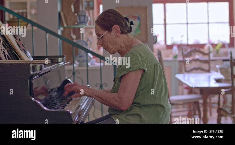 Old woman playing a grand piano at her home Stock Video Footage - Alamy