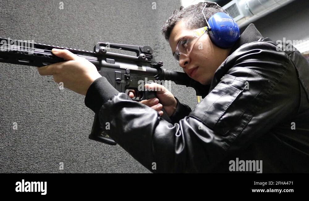Man posing with gun Stock Videos & Footage - HD and 4K Video Clips - Alamy