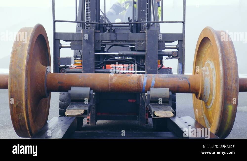 Lifting train wheelbase from an iron pallet with forklift 4K Stock ...
