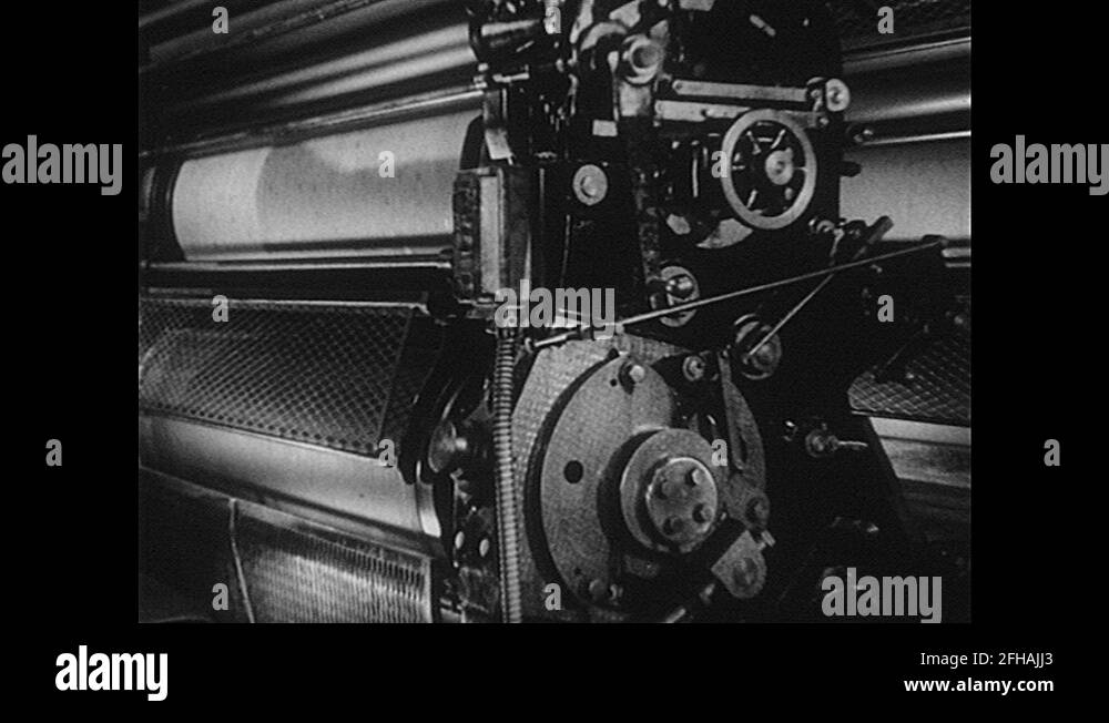1940s: Printing press. Man removes map and lays on table. Men study map ...