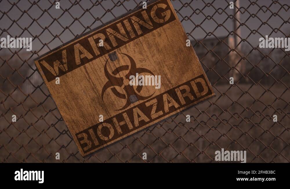 Biohazard Zone. Biohazard sign attached to a chain link fence warns of ...