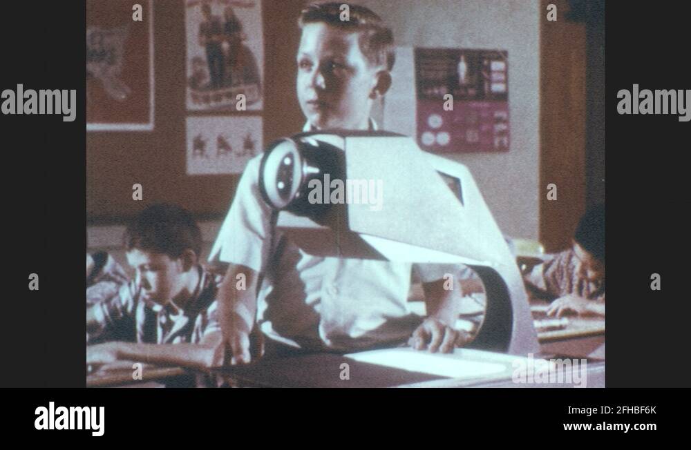 1960s: Classroom. Boy stands at overhead projector and reads. List of ...