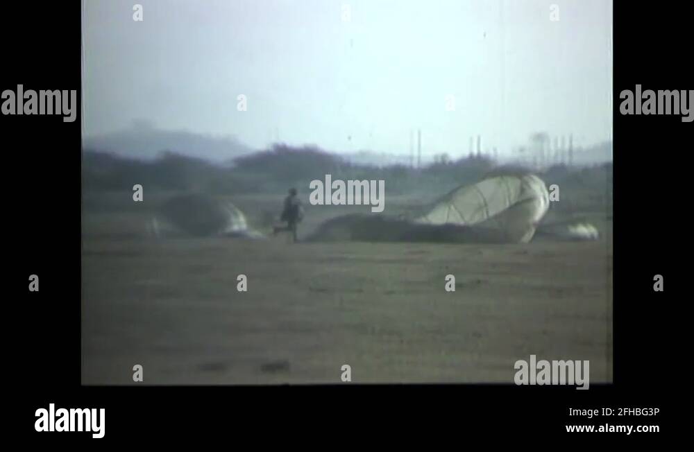 CIDG soldiers parachutes float down during airborne training - 1969 ...