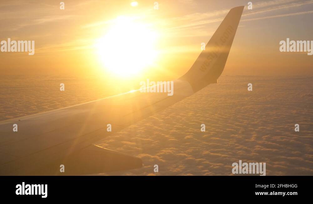 Airplane window view above the clouds of sun rays flaring Stock Video ...