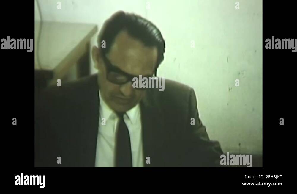 U.S. and Latin Military Group advisors seated around conference table ...