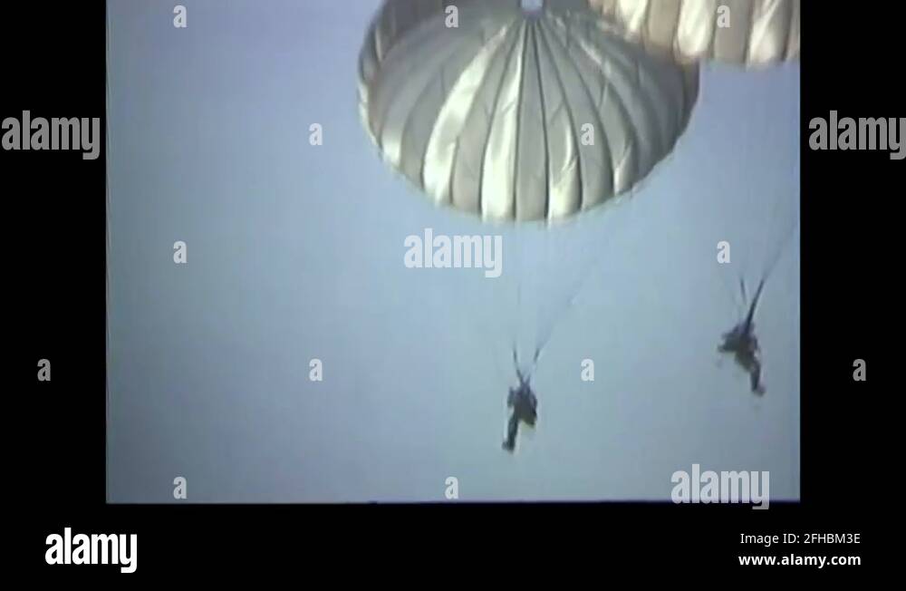 CIDG soldiers parachutes float down during airborne training - 1969 ...