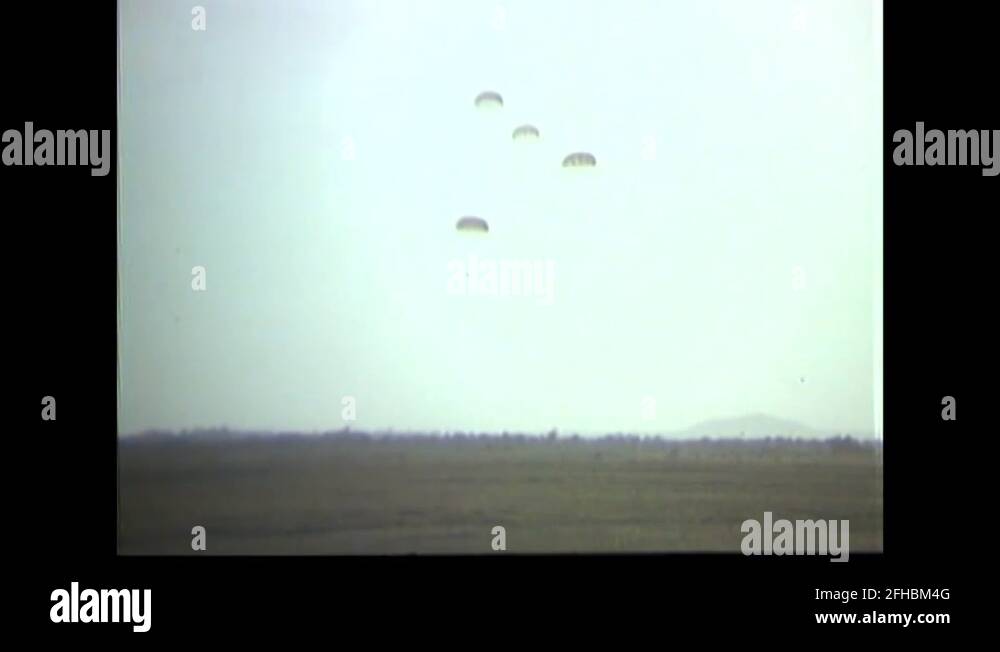 CIDG soldiers parachutes float down during airborne training - 1969 ...