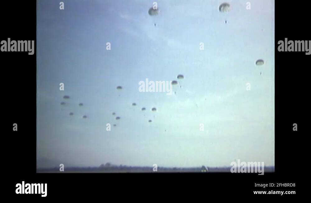 CIDG soldiers parachutes float down during airborne training - 1969 ...