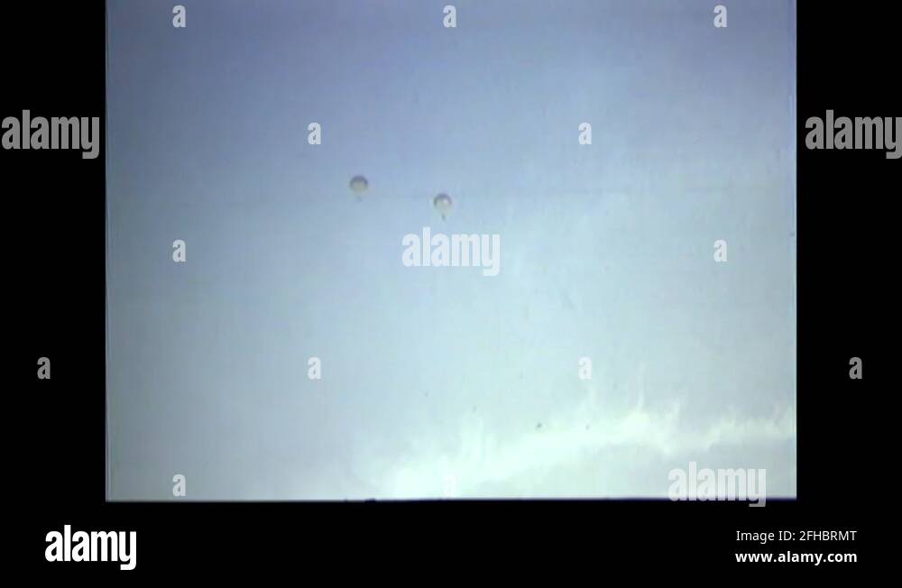 CIDG soldiers parachutes float down during airborne training - 1969 ...