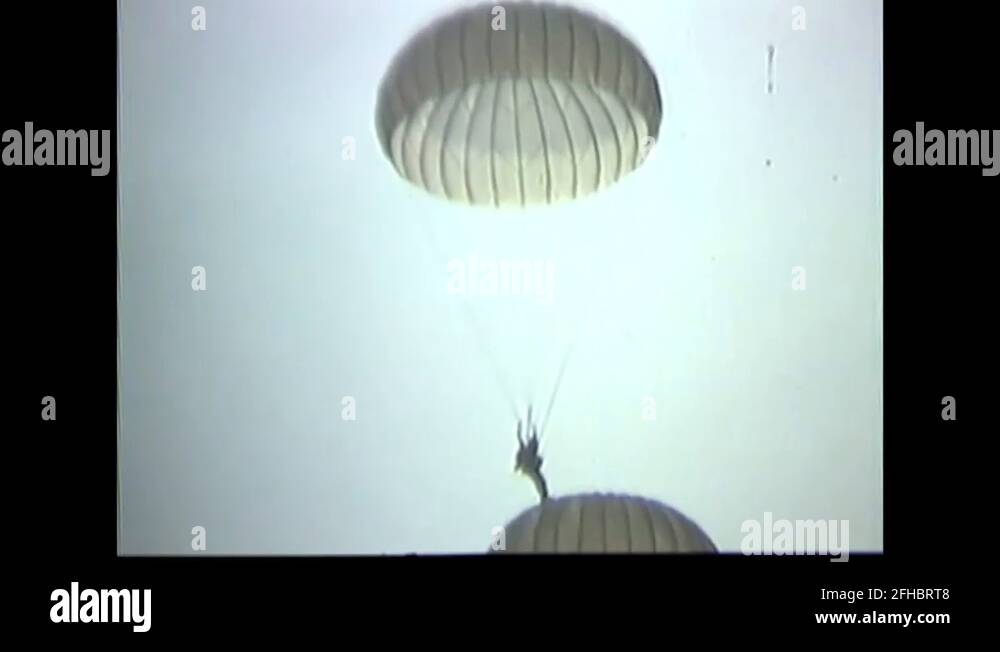 CIDG soldiers parachutes float down during airborne training - 1969 ...