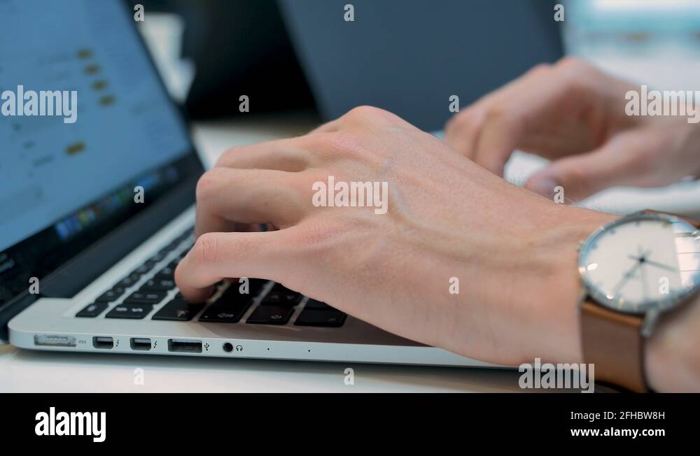 Guy writing and working on a laptop Stock Video Footage - Alamy