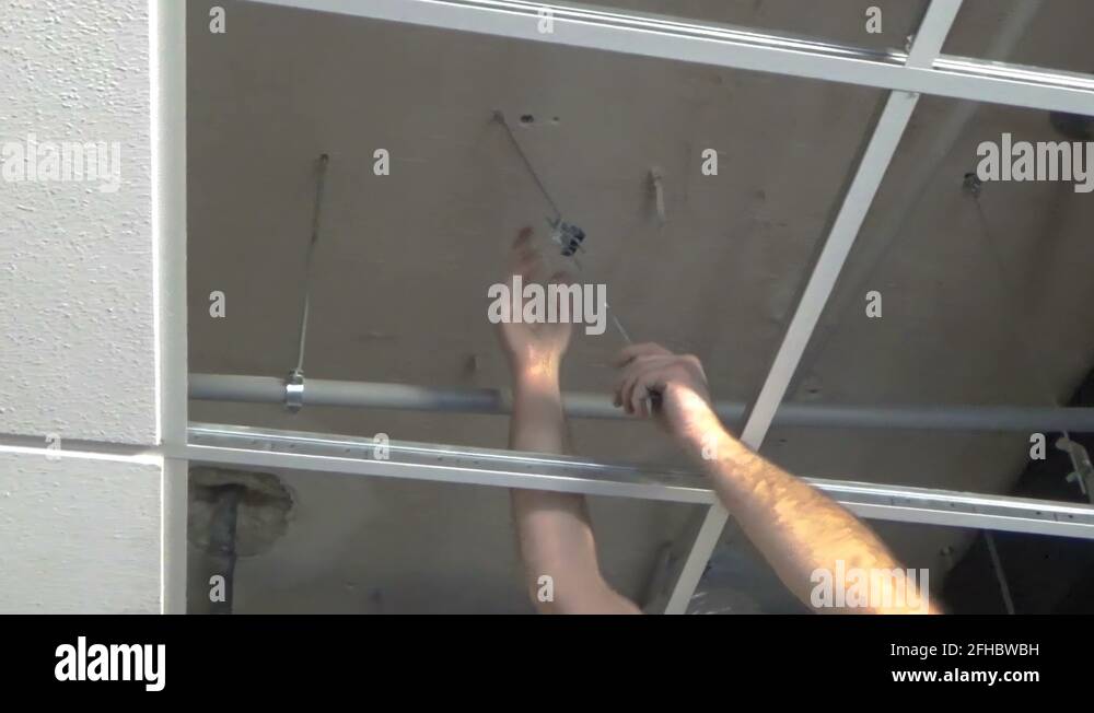 Construction worker performs a suspended ceiling maintenance Stock ...