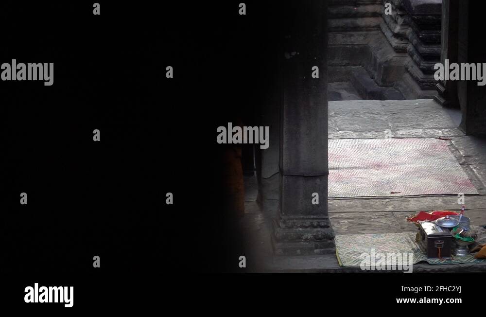 SLOW MOTION: Peeking past stone ledge to see a Buddhist monk look ...