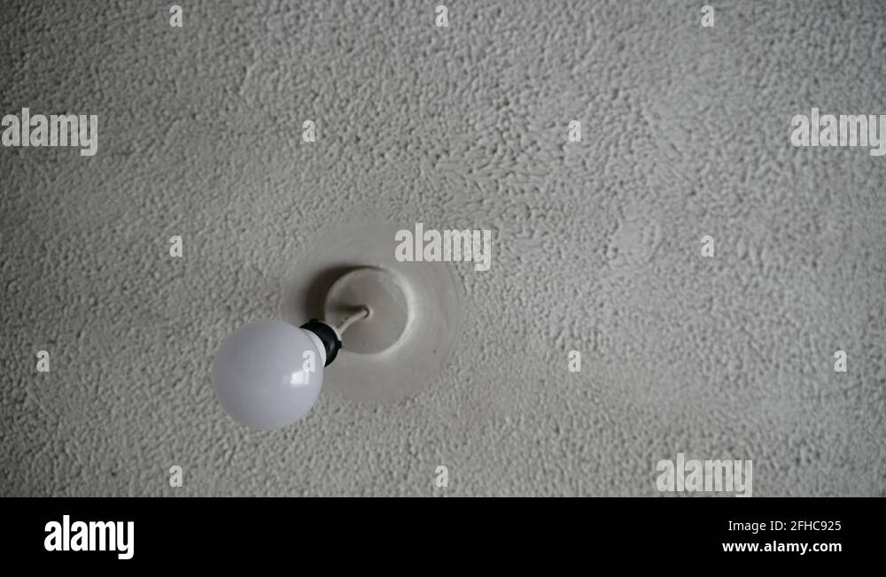 White light bulb hanging from ceiling ceiling Stock Videos & Footage ...